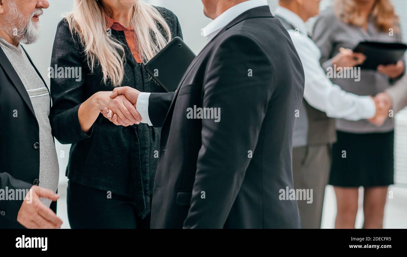 group of business people greet each other in the office lobby Stock ...