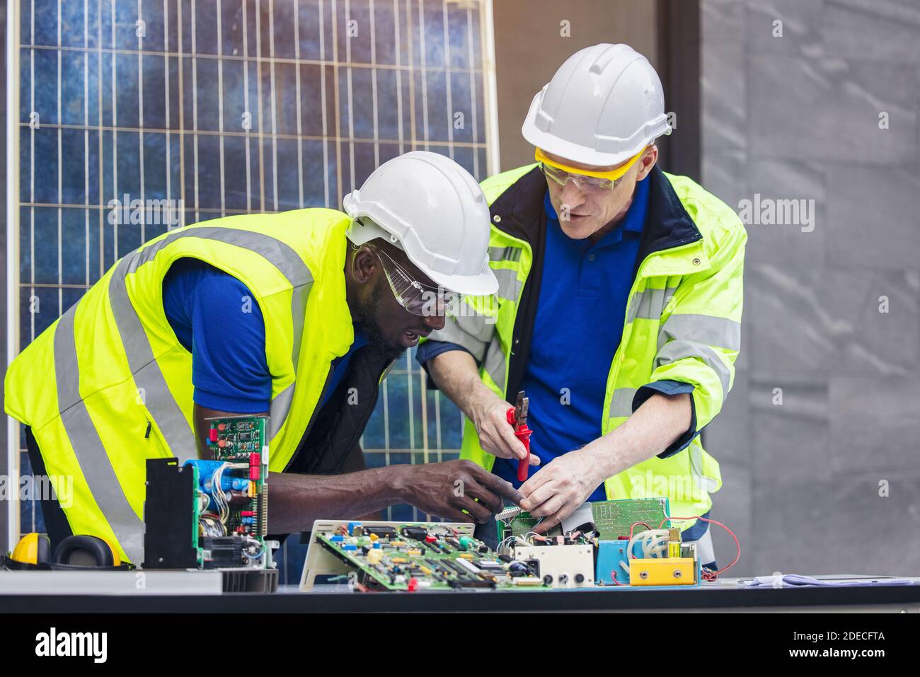 Engineer working repairing electric panel with solar panels background ...
