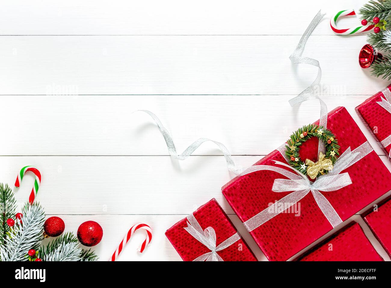 Colorful shiny red Christmas gift boxes and decoration items on white ...