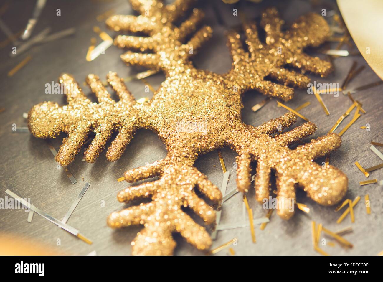 Gold glittered star-shaped snowflake decoration on a rustic surface ...