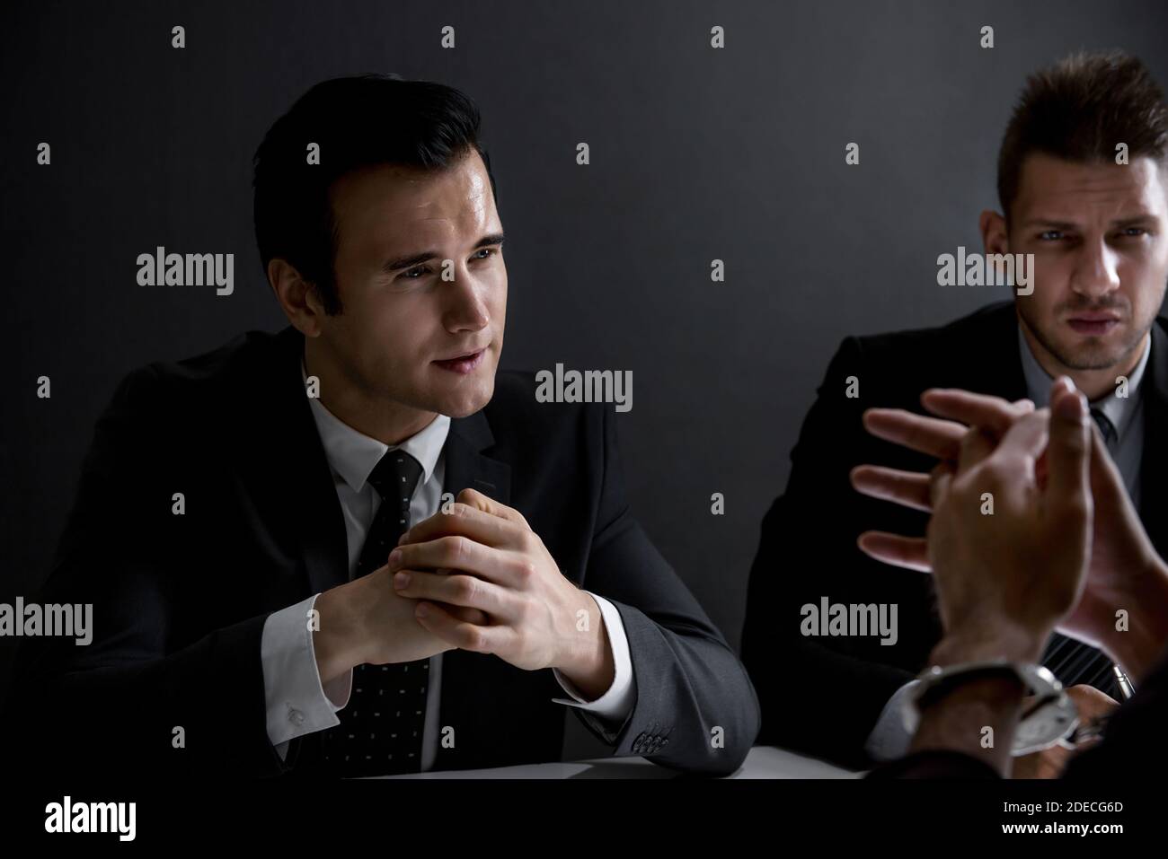 Detectives interview suspect or criminal man wearing handcuffs in ...