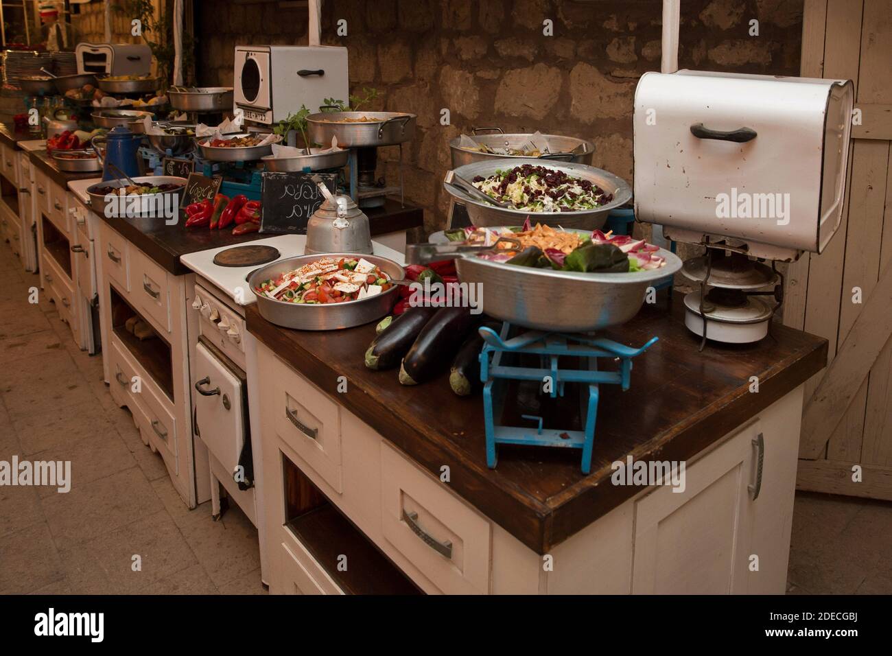 Rustic style buffet table laid out with an assortment of food at an ...