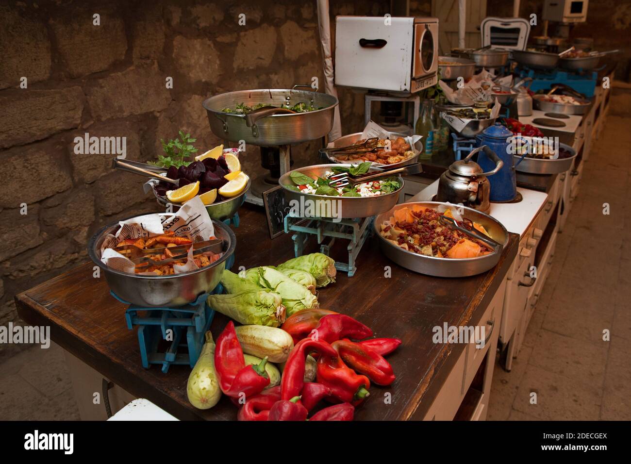 Rustic style buffet table laid out with an assortment of food at an ...