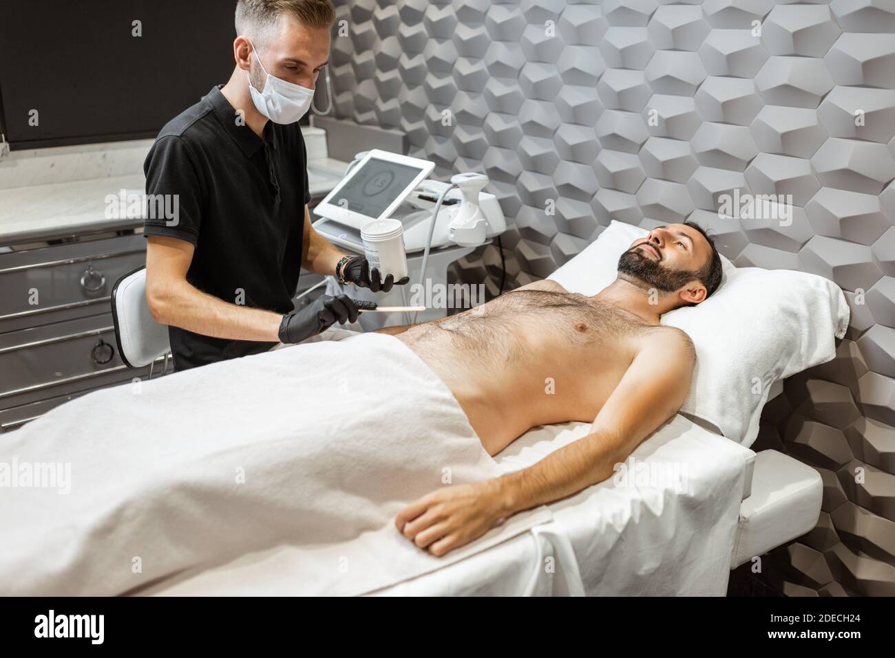 Man with a doctor at luxury Spa salon. Preparation for liposuction ...