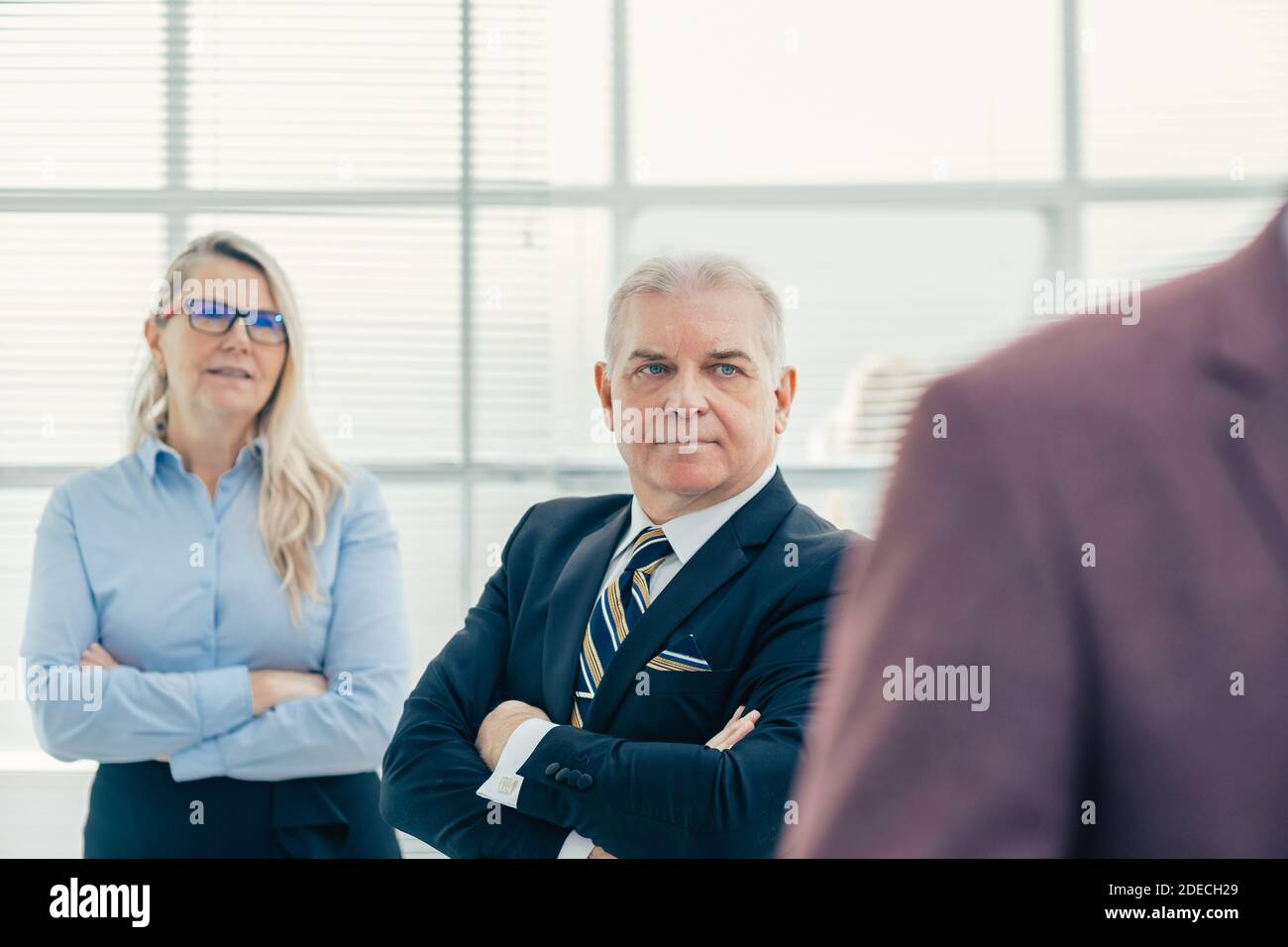 close up. thoughtful serious employees standing in the office Stock ...