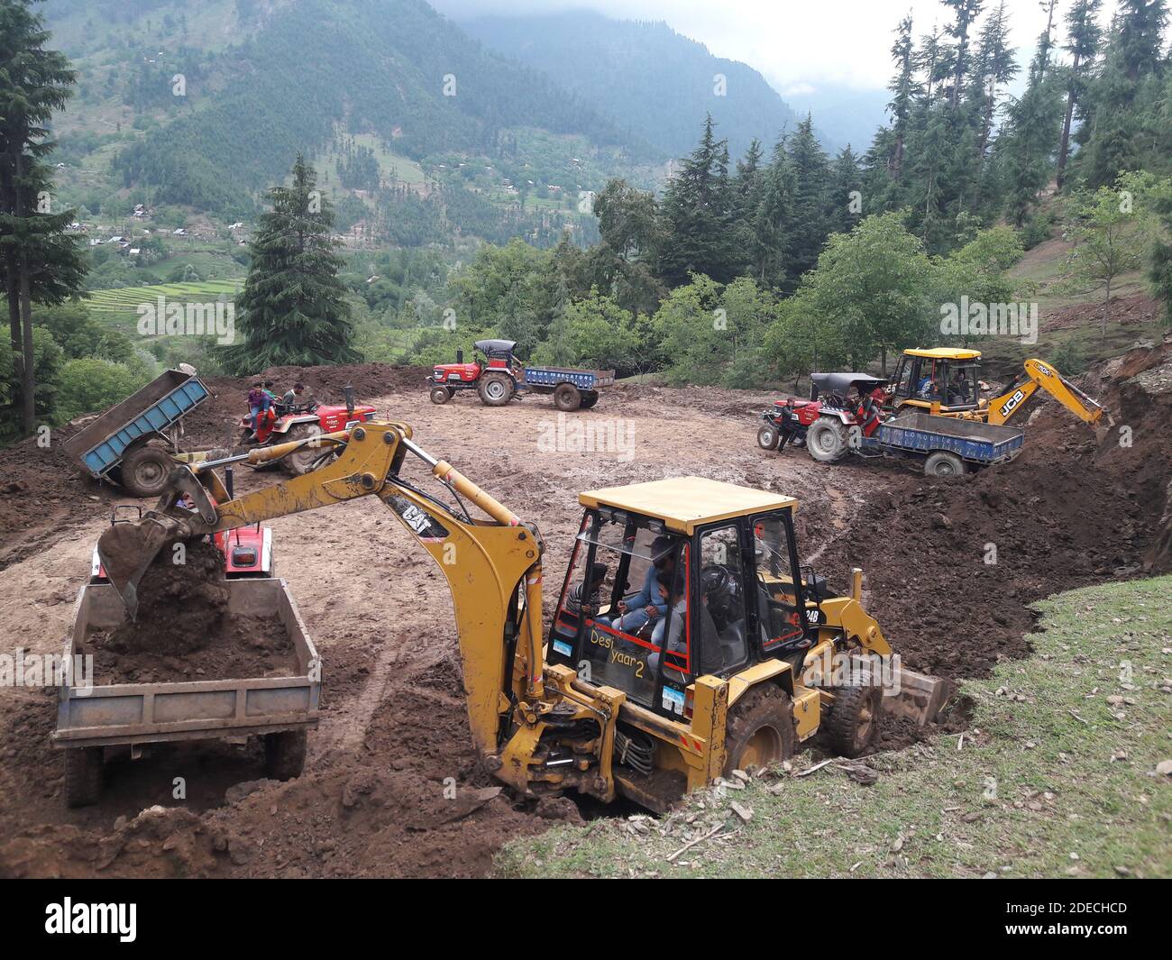 JCB working at ground to build a playground in kupwara. Green forests ...
