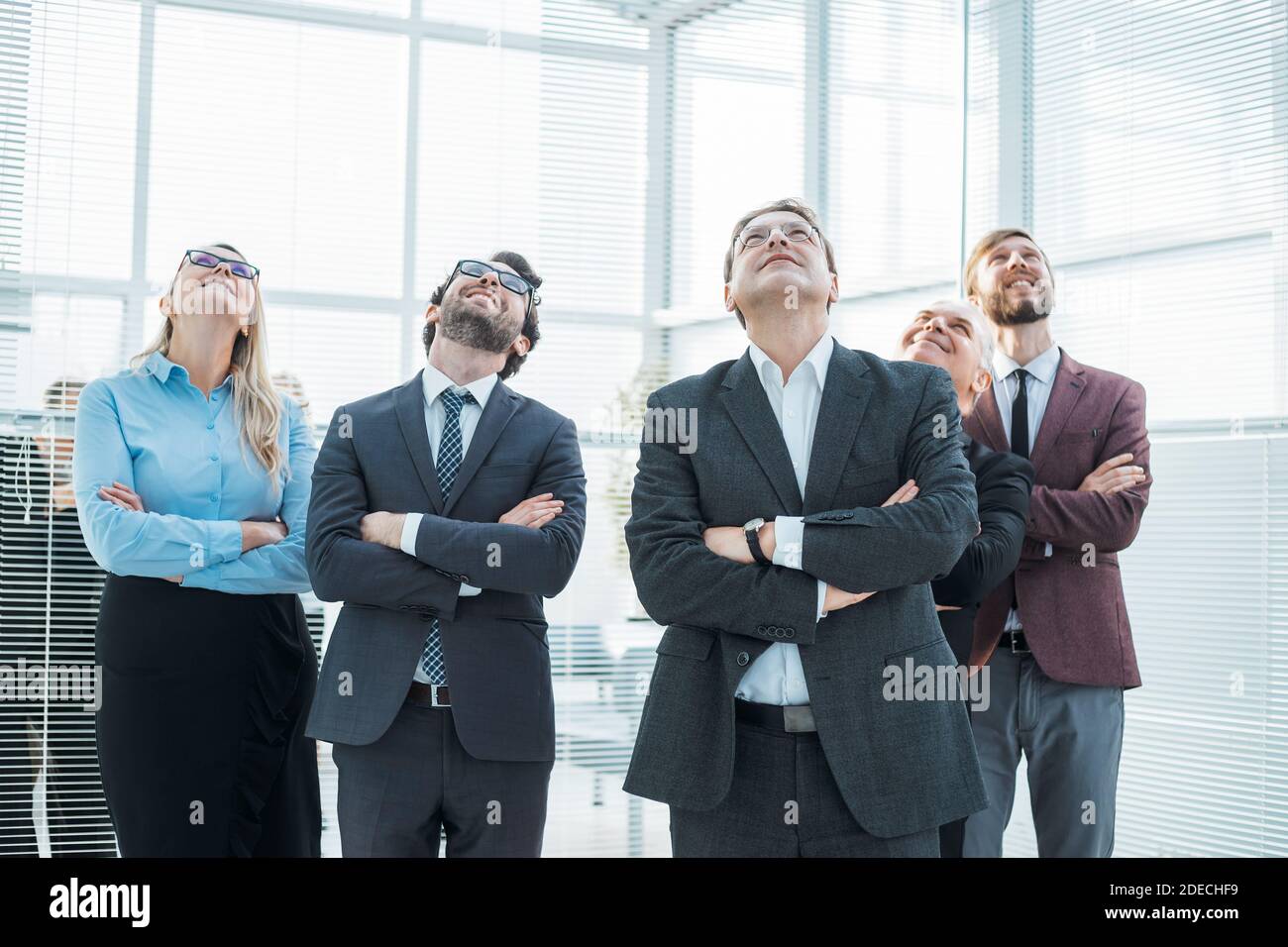 group of employees look up in admiration Stock Photo - Alamy