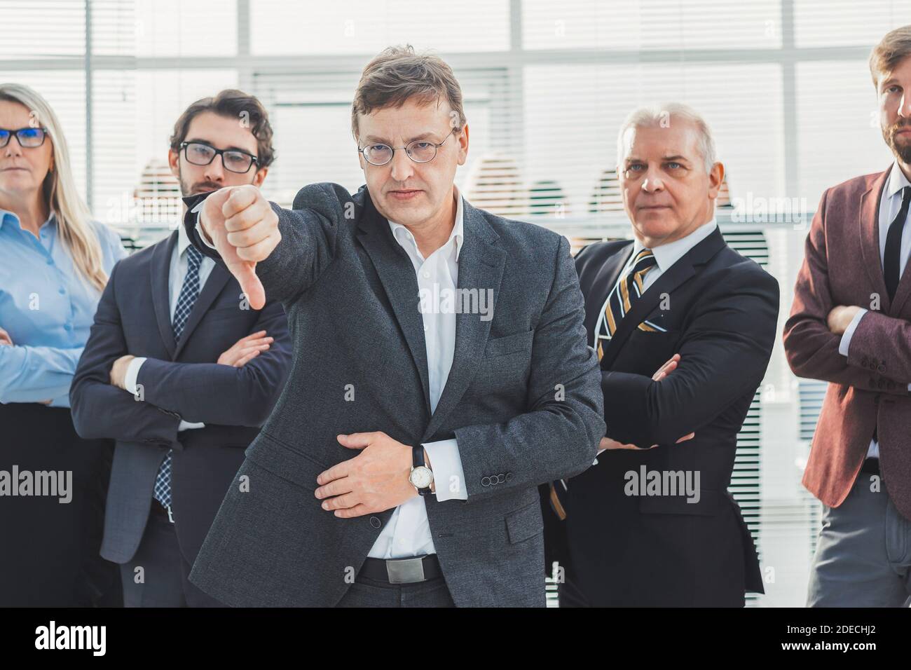 close up. angry businessman giving a thumbs down Stock Photo - Alamy