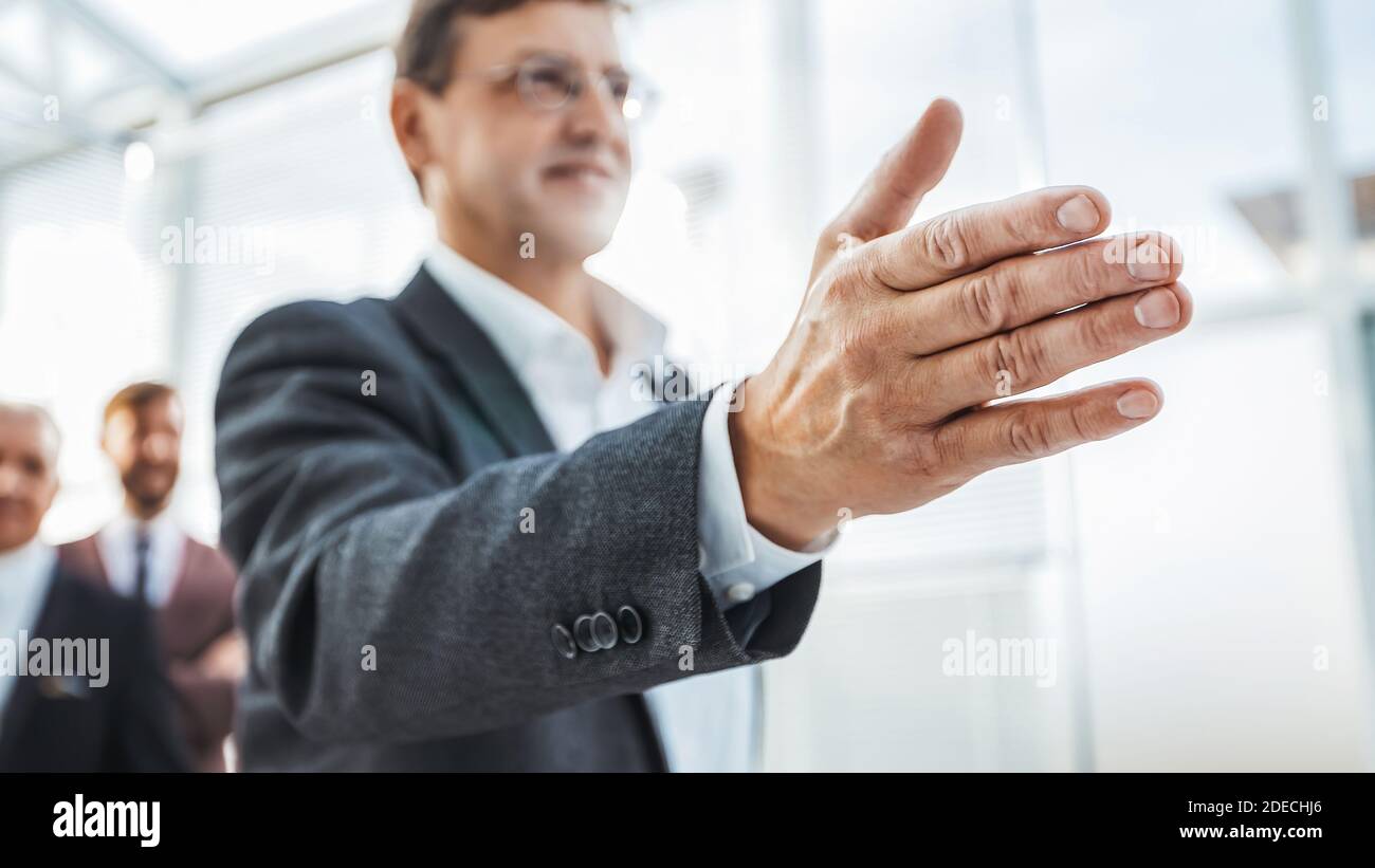 business man greeting you in the new office Stock Photo - Alamy