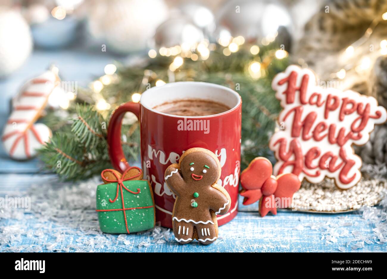 Gingerbread man near a red cup on a cozy blurry winter background ...