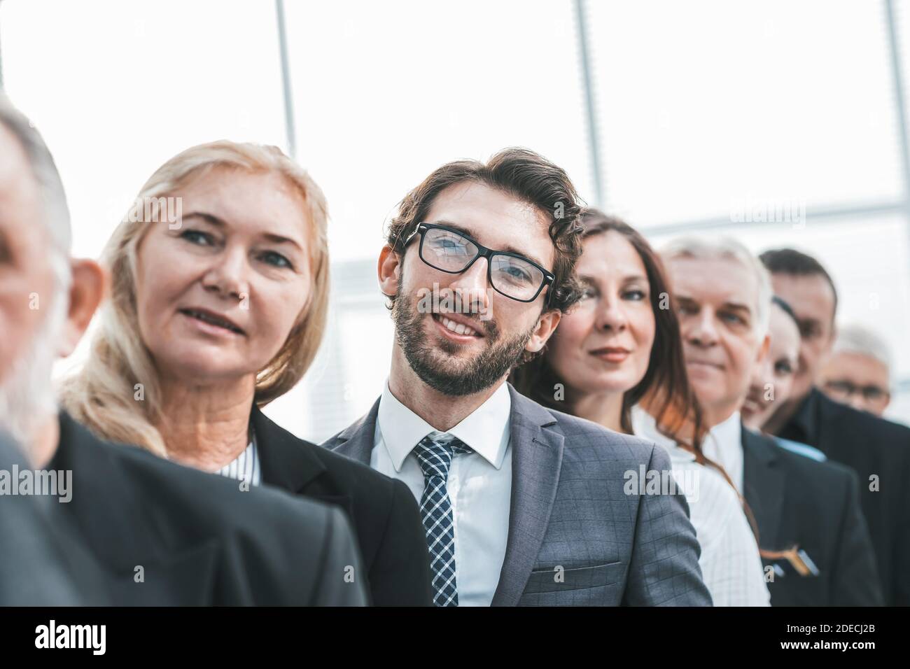 close up. an adult business woman standing in a row of her colleagues ...
