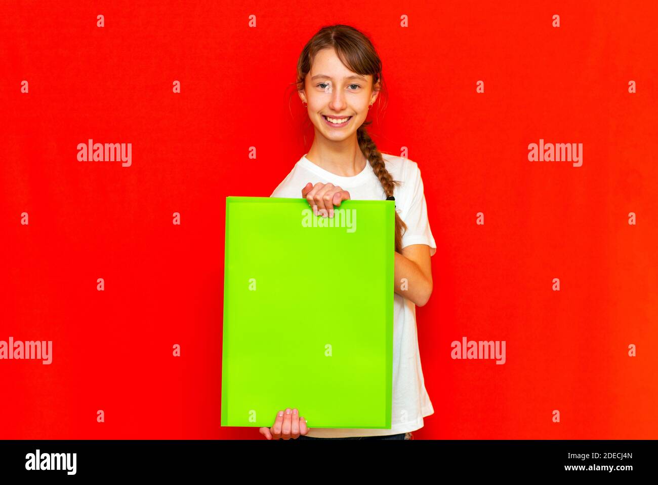 Front view teenager girl showing blank paper.Mock up,banner,copy space ...