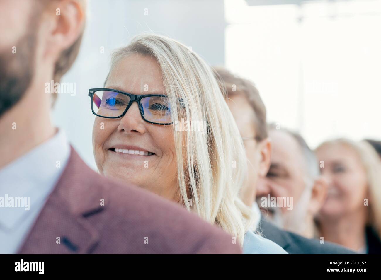 close up. smiling business people standing in a row Stock Photo - Alamy