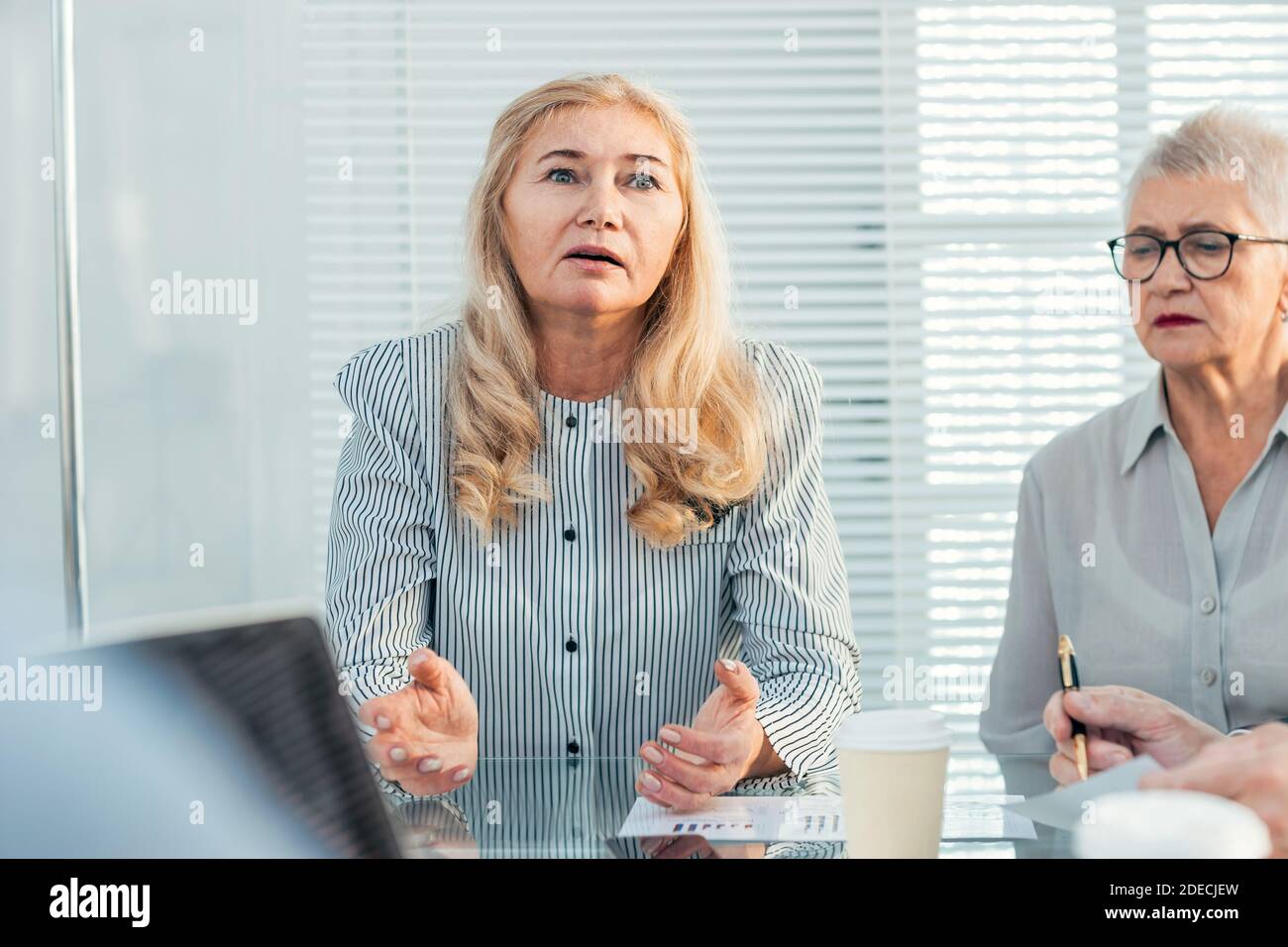 serious business woman explaining something to her colleagues Stock ...