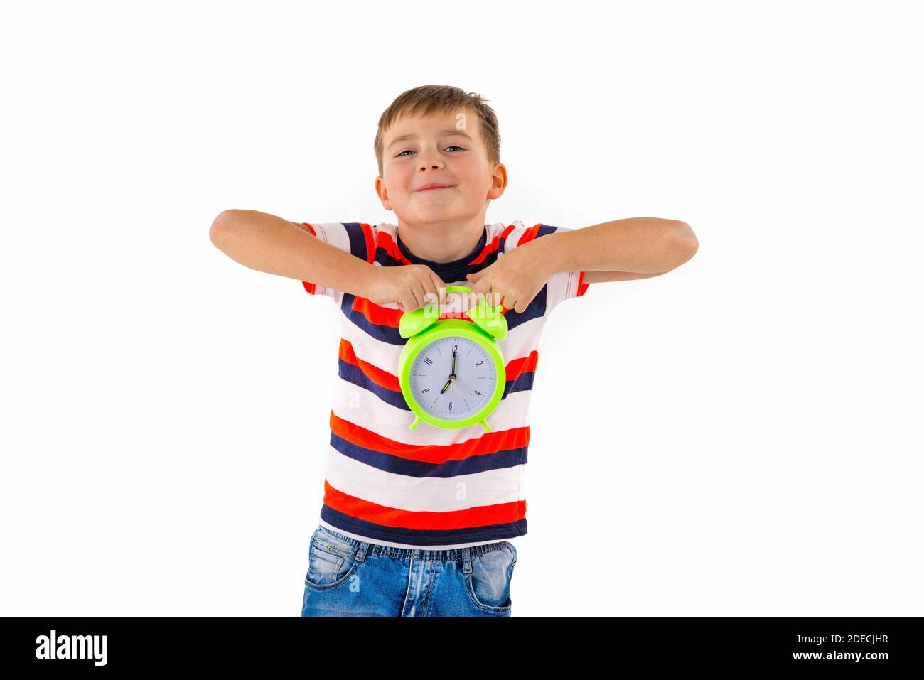 Attractive cute boy holding alarm clock on white isolated studio ...