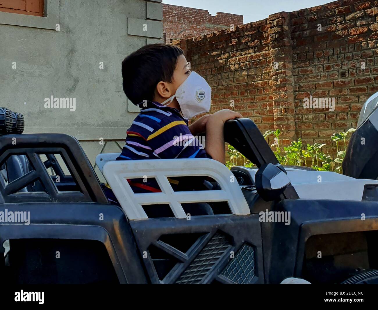 Masked Children playing games and running in a public park. Wearing ...