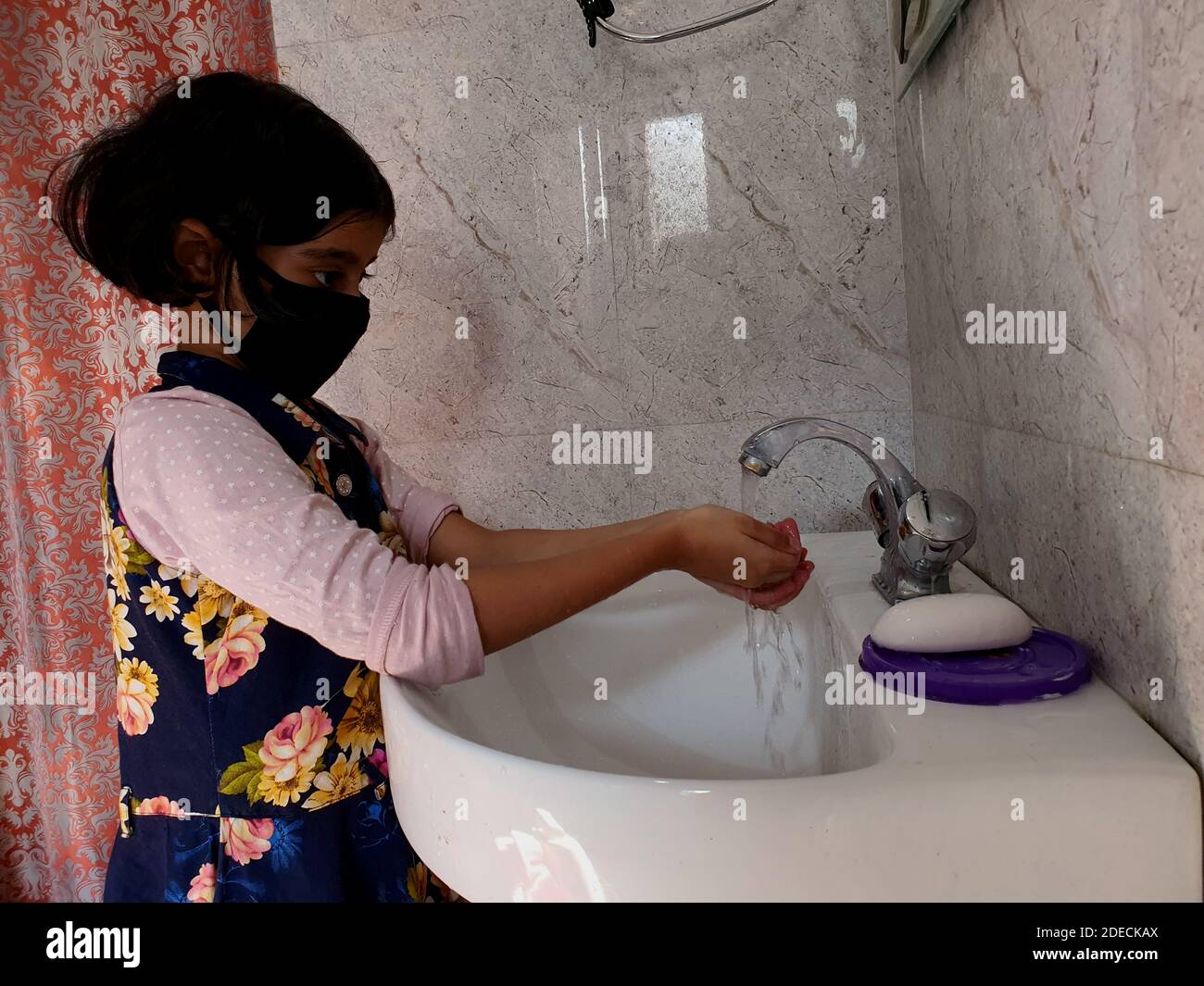 Washing hands in bathroom by masked Children during coronavirus ...