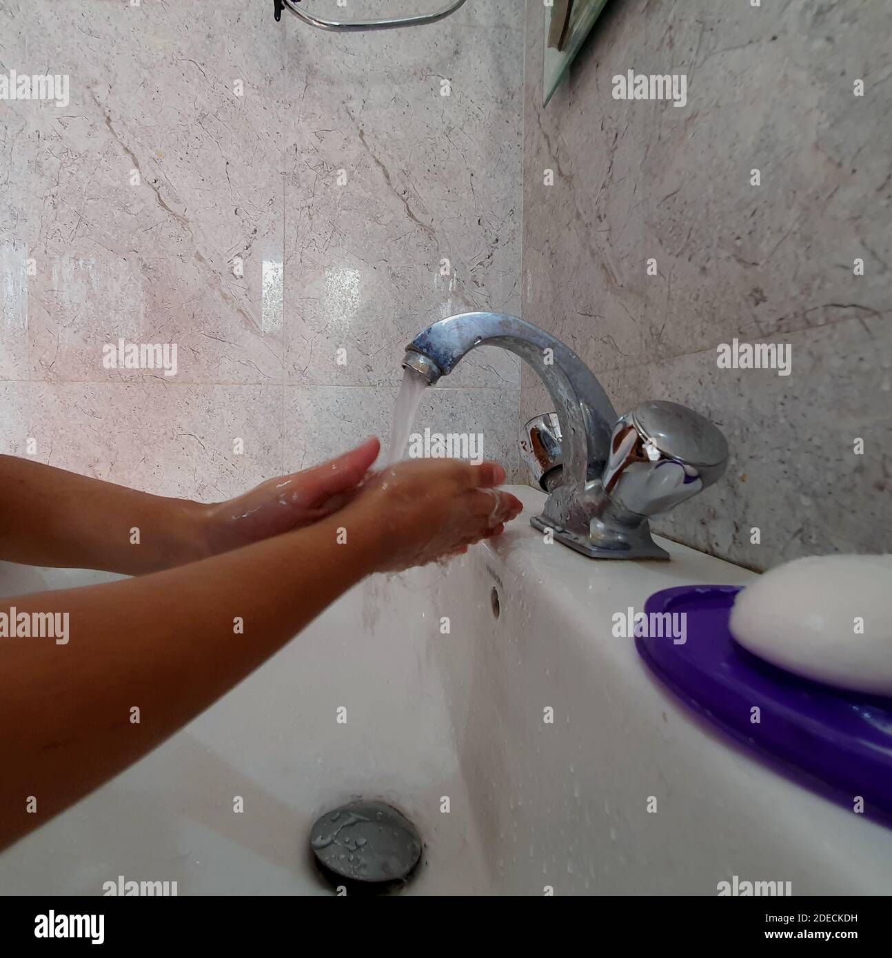 Washing hands in bathroom by masked Children during coronavirus ...