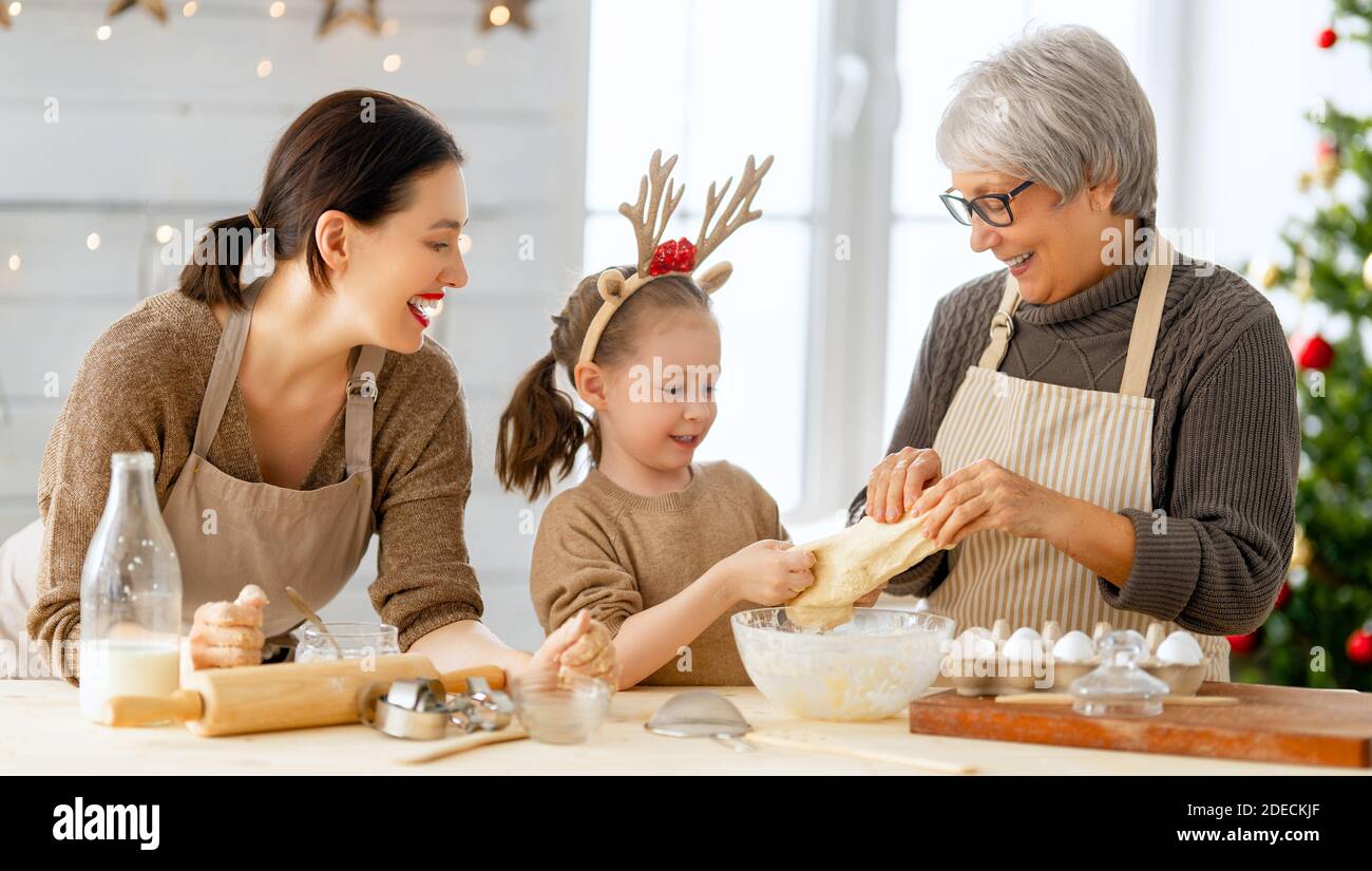 Merry Christmas and Happy Holidays. Family preparation holiday food ...