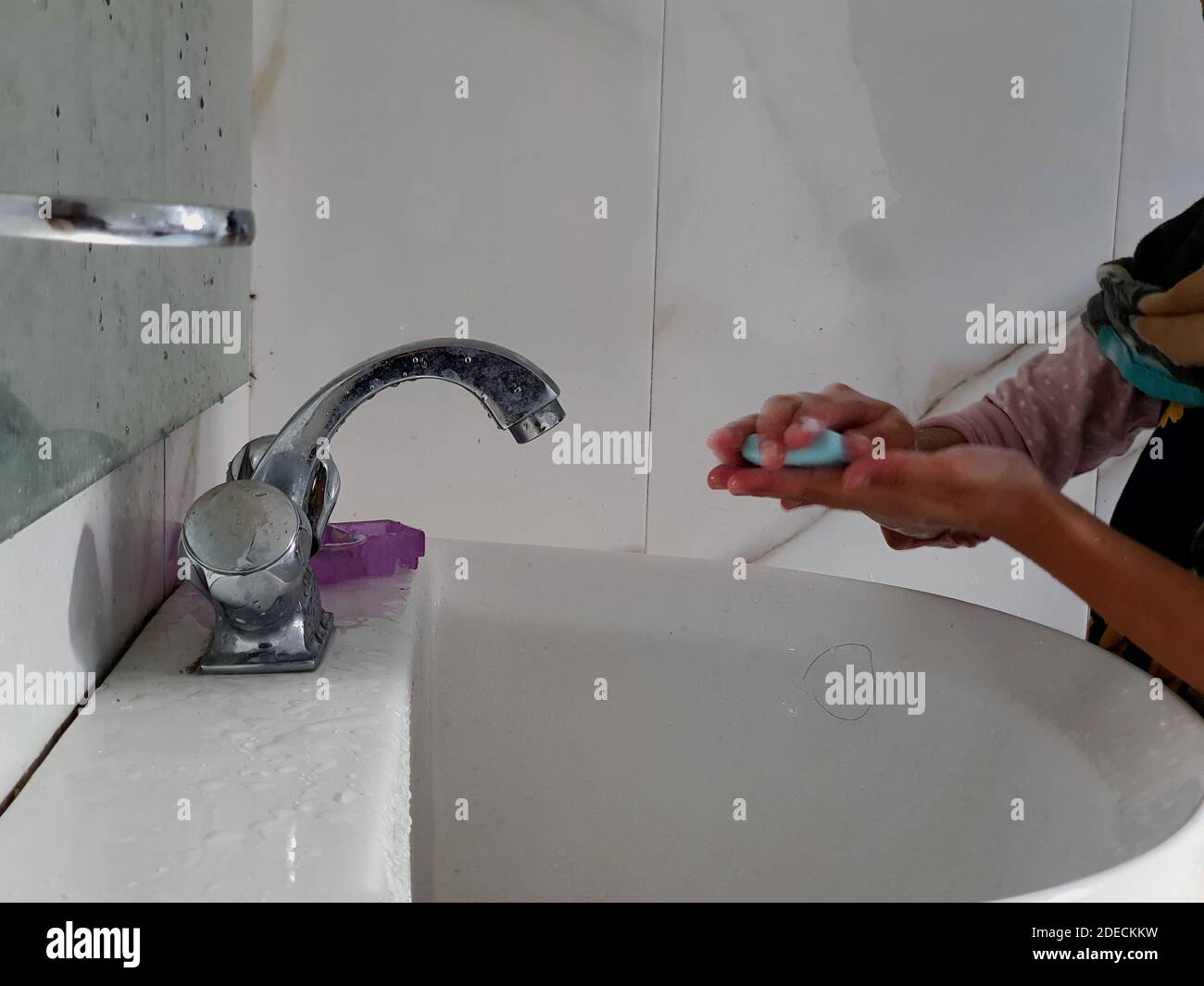 Washing hands in bathroom by masked Children during coronavirus ...