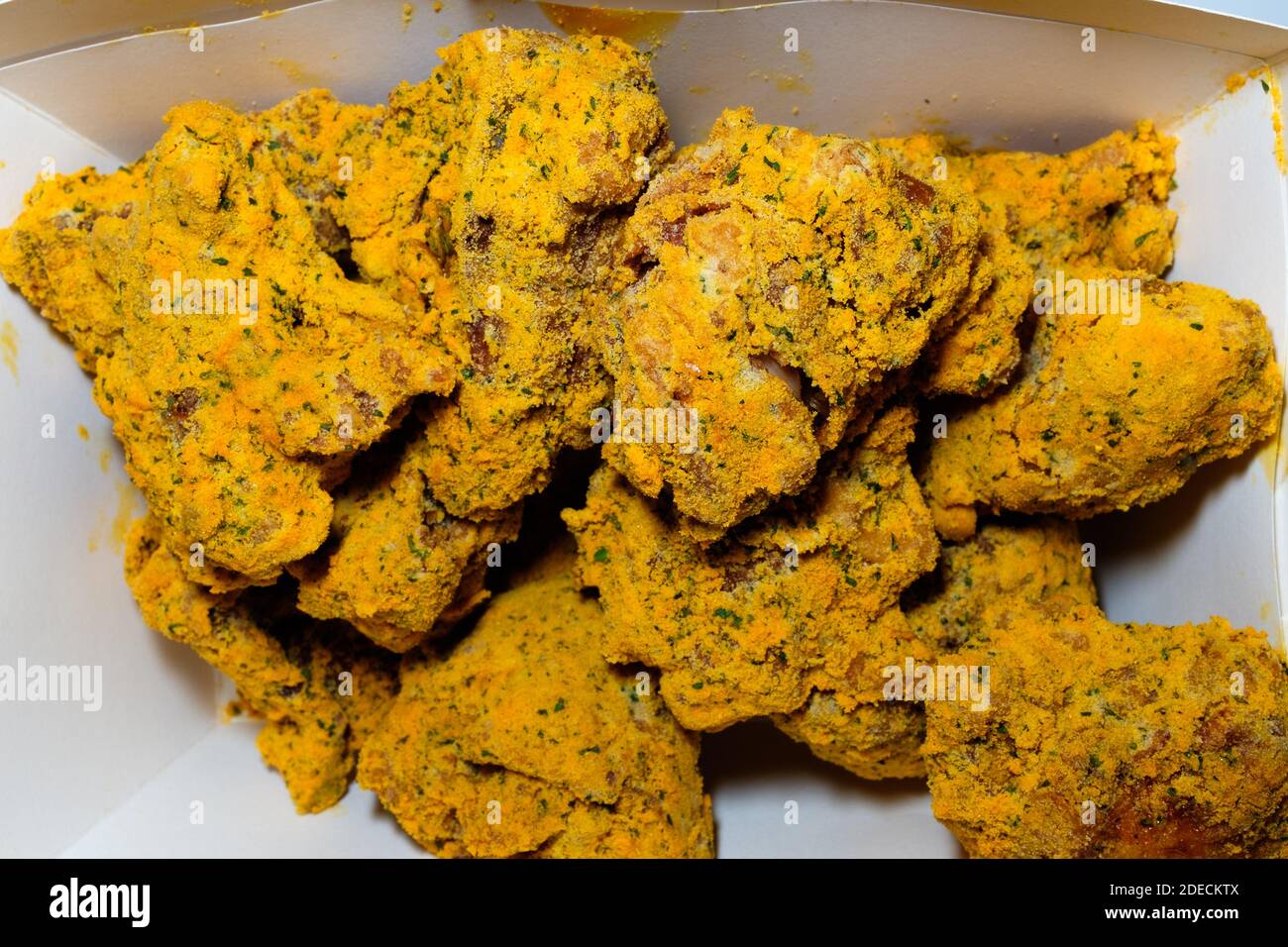 Fried Chicken Sprinkled with Yellow Seasoning Stock Photo - Alamy
