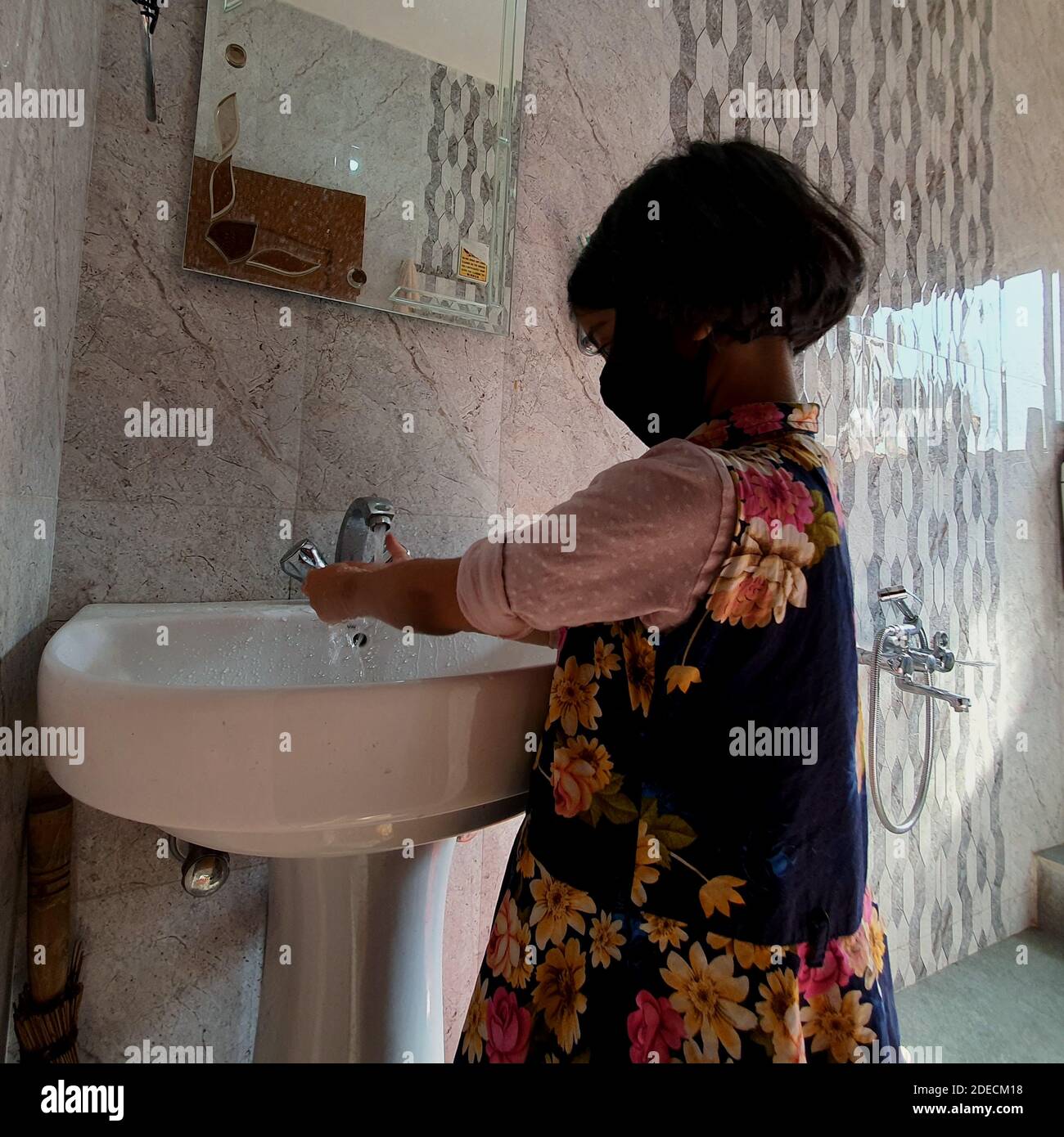 Washing hands in bathroom by masked Children during coronavirus ...