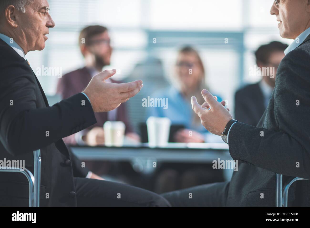business colleagues argue sitting at the office table Stock Photo - Alamy
