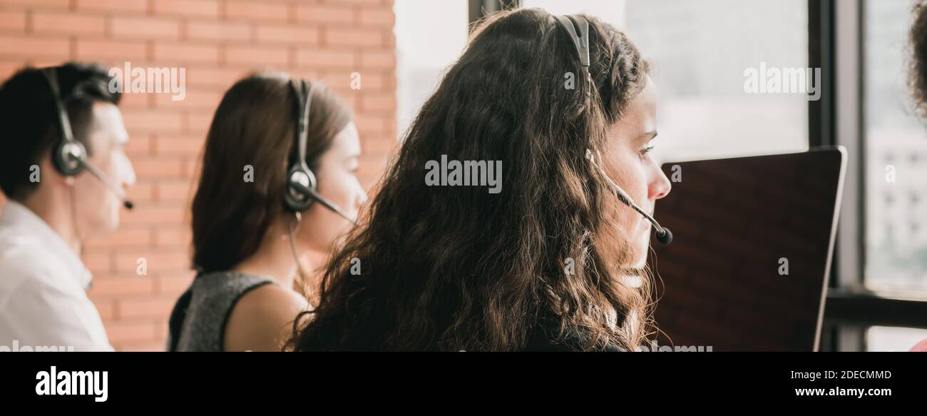 Telemarketing call center staff team wearing headsets providing ...