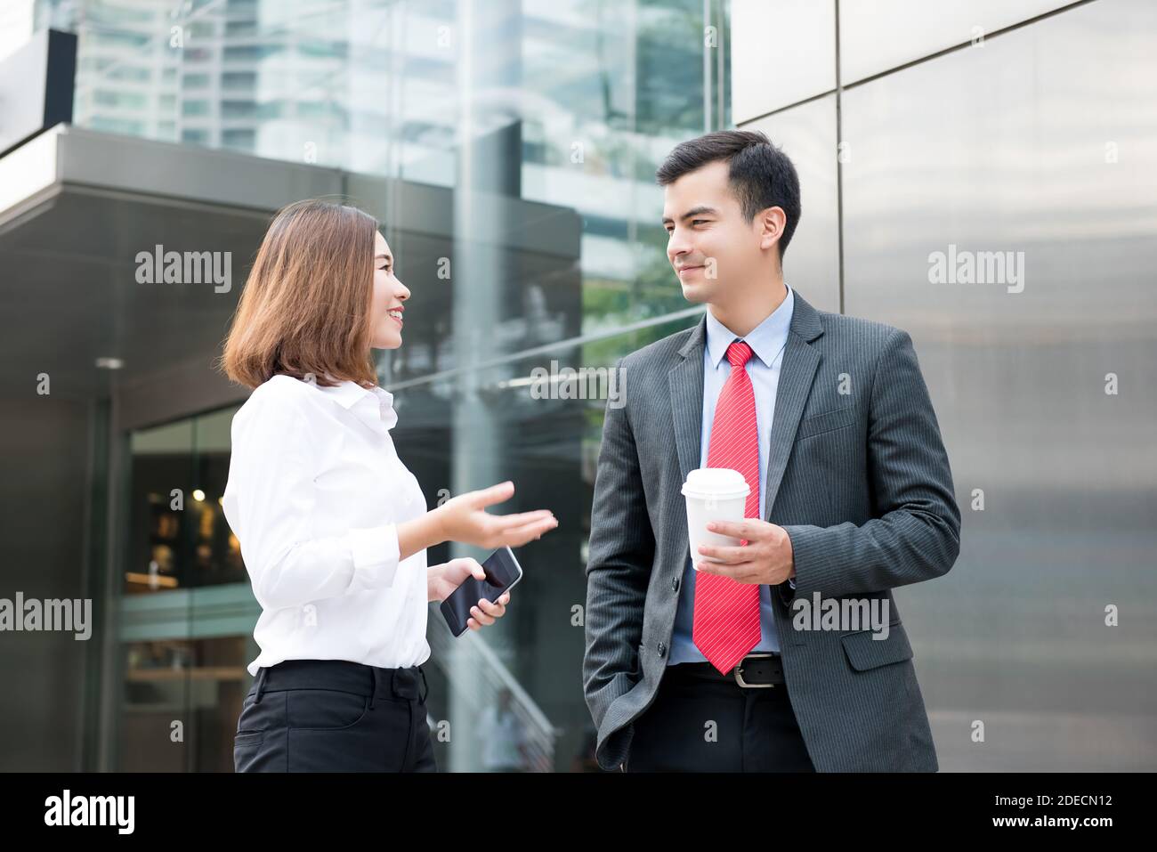 Handsome Colombian Businessman and Asian businesswoman standing and ...