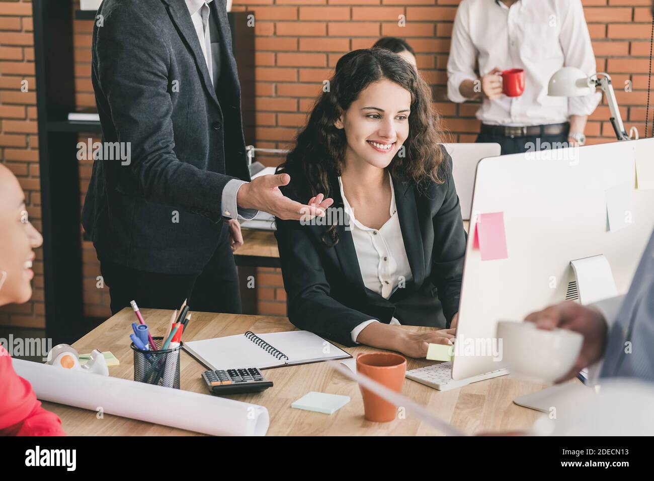 Young Russian business woman working with her colleague in front of ...