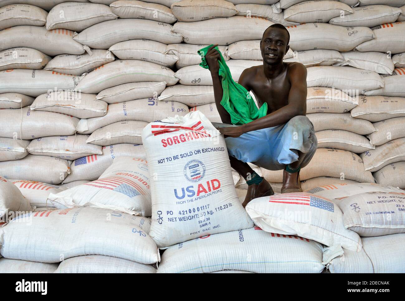 A man prepares food rationing in Kule refugee camp in Ethiopia due to ...