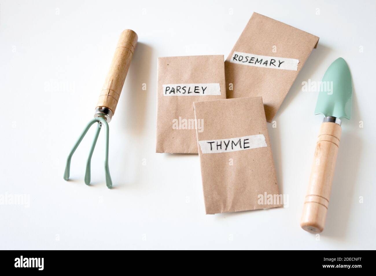 gardening tools, paper bags with seeds, planting season Stock Photo - Alamy