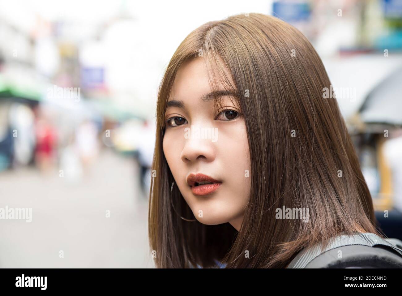 Young attractive Asian woman tourist standing in city street market in ...