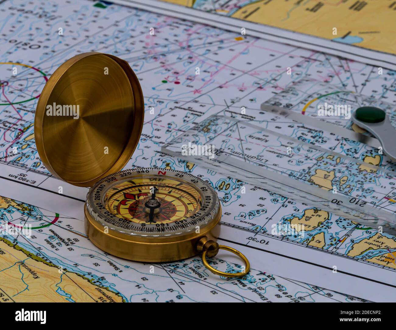 Vintage golden compass and a navigational ruler on nautical maps Stock ...
