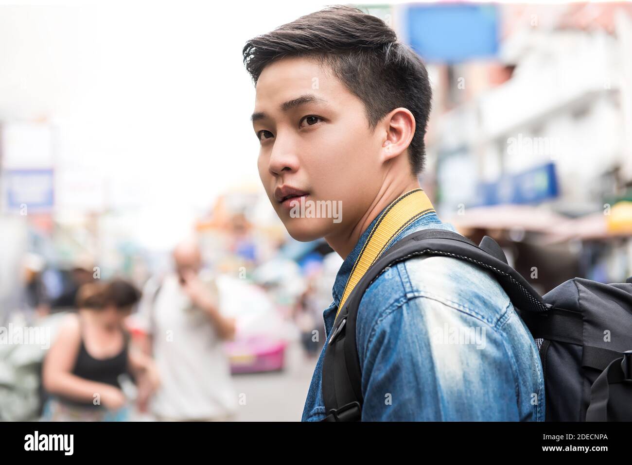 Young independent handsome Asian man tourist backpacker traveling alone ...