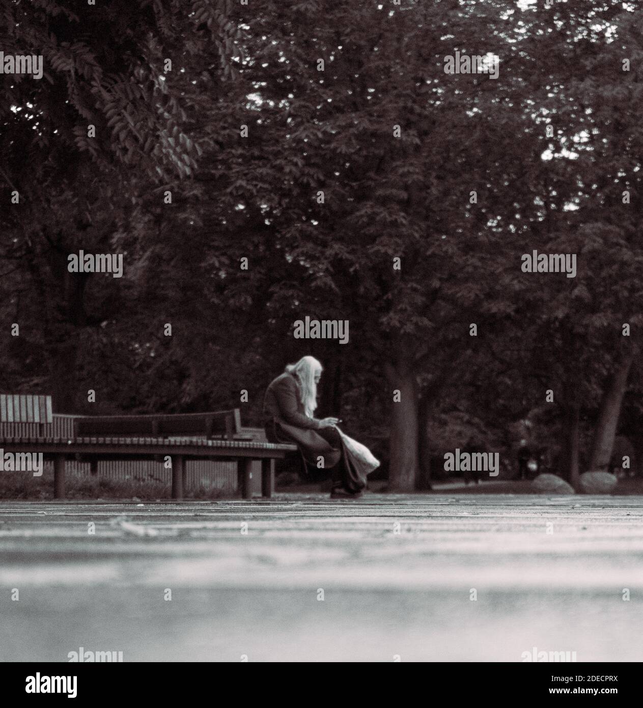 Person sitting alone hi-res stock photography and images - Alamy