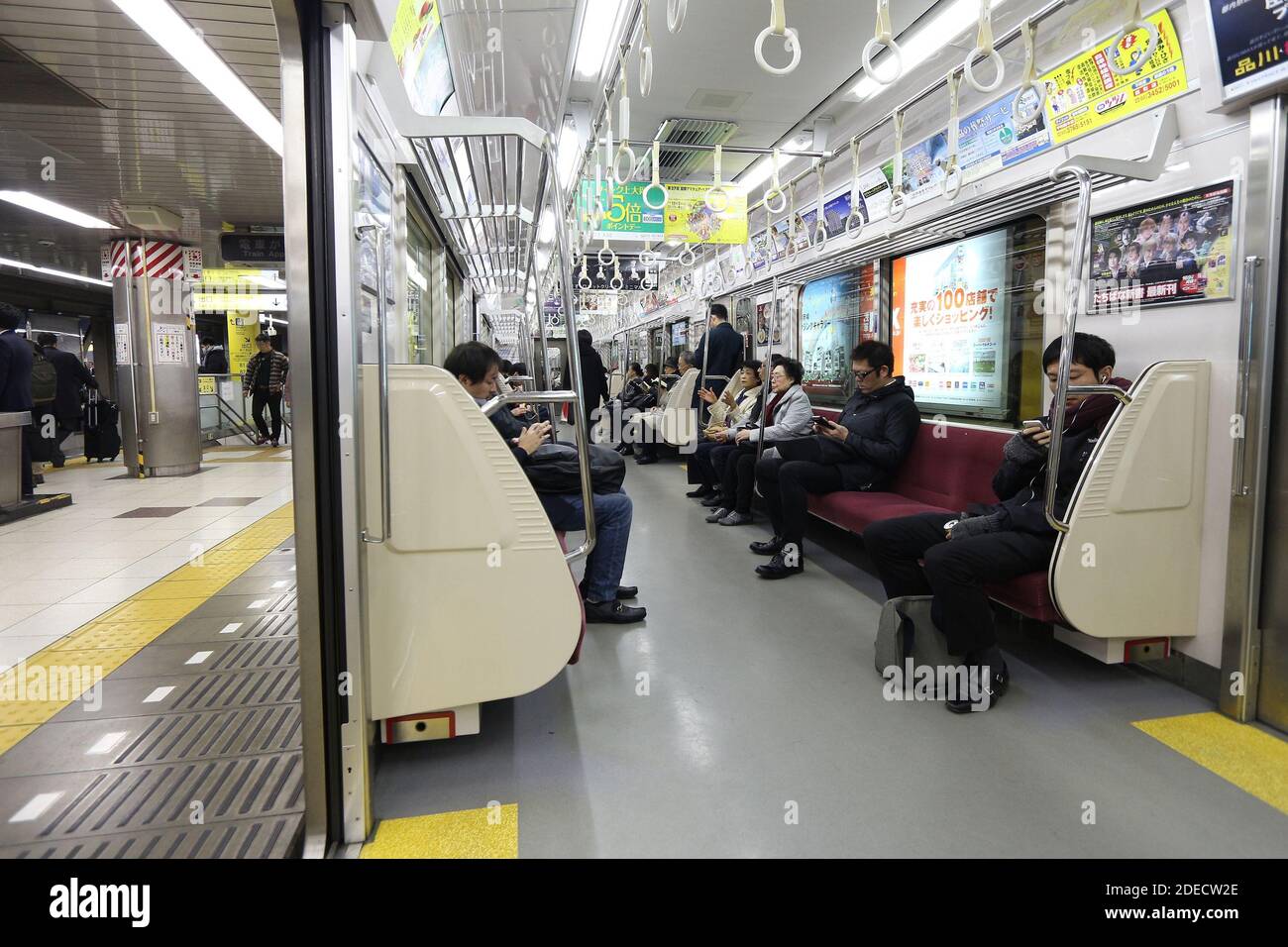 TOKYO, JAPAN - NOVEMBER 30, 2016: Passengers ride a metro train in ...