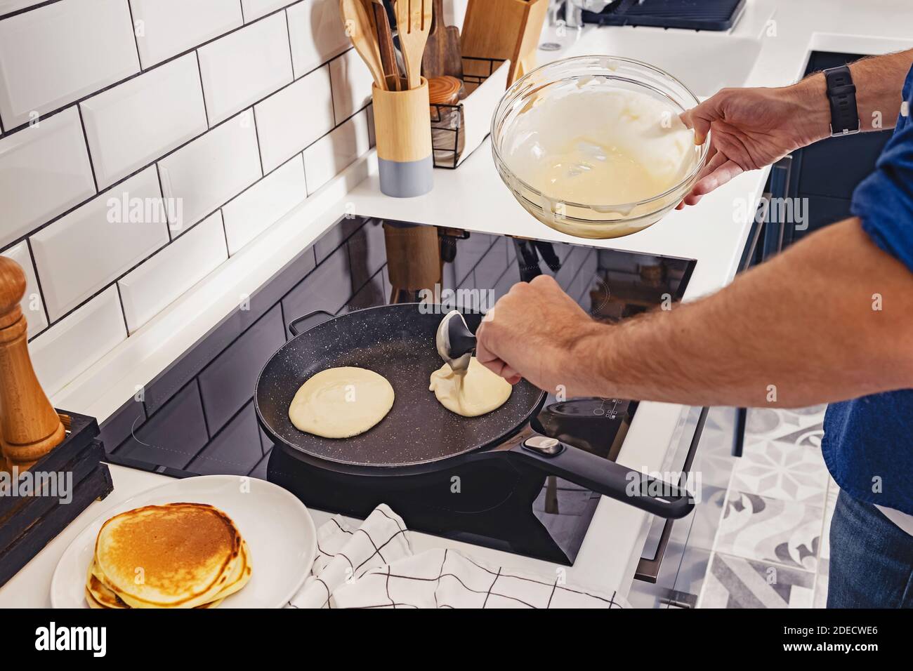 Man cooking pancakes at his modern kitchen Stock Photo - Alamy