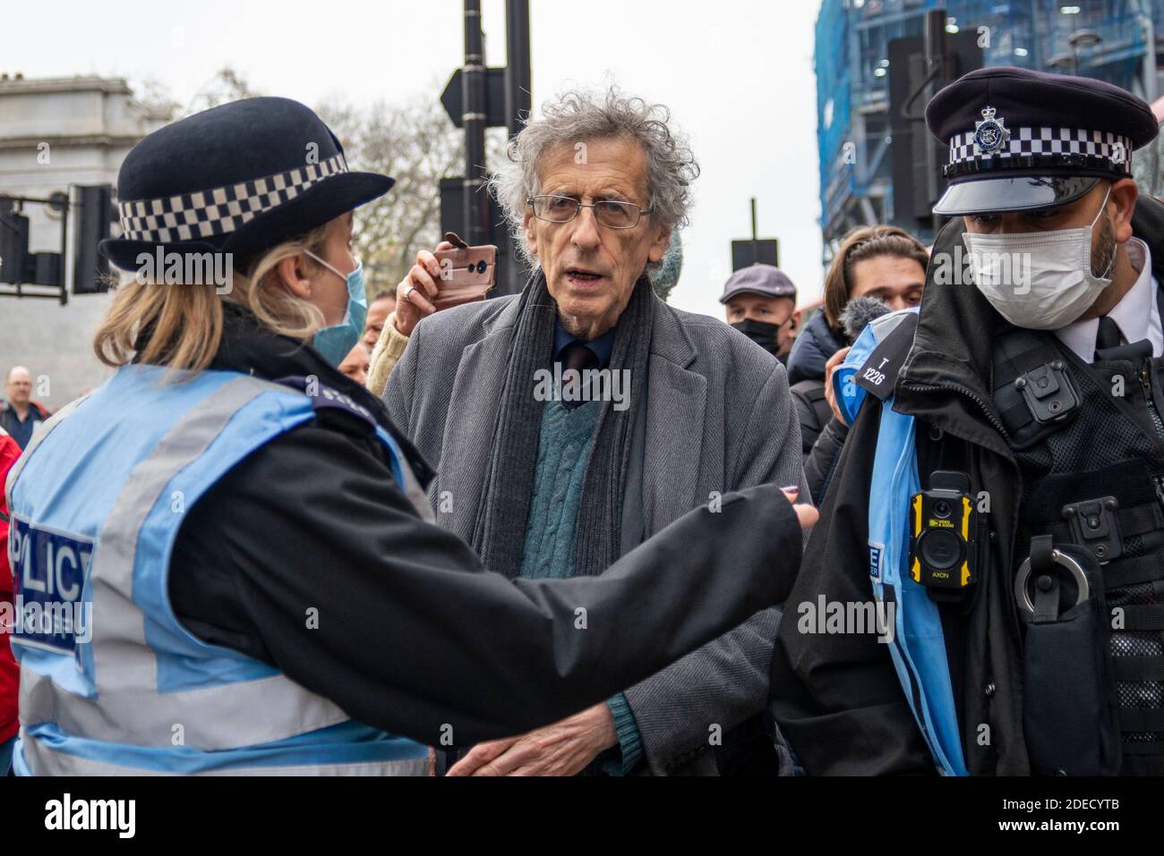 Piers Corbyn being stopped by police liaison officers at an anti ...