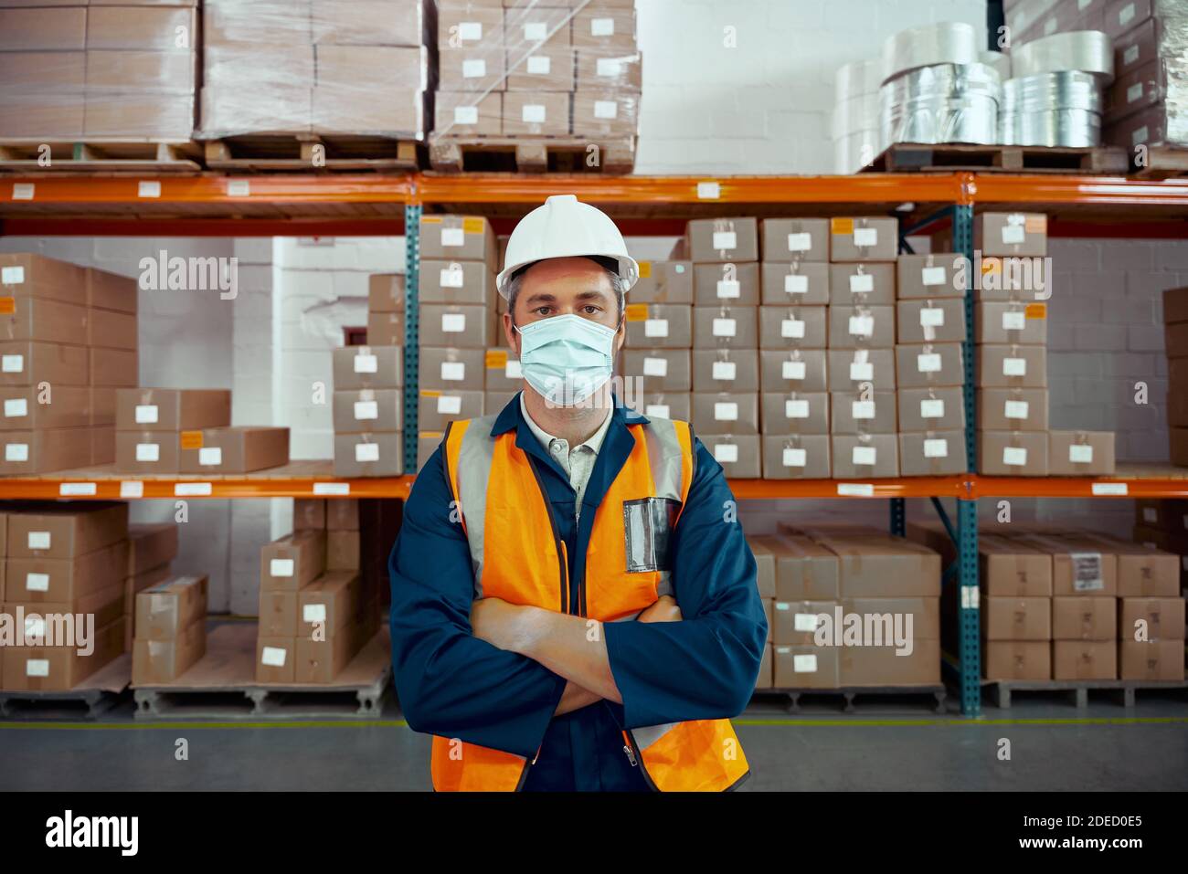 Portrait of a confident factory male worker wearing protective helmet ...