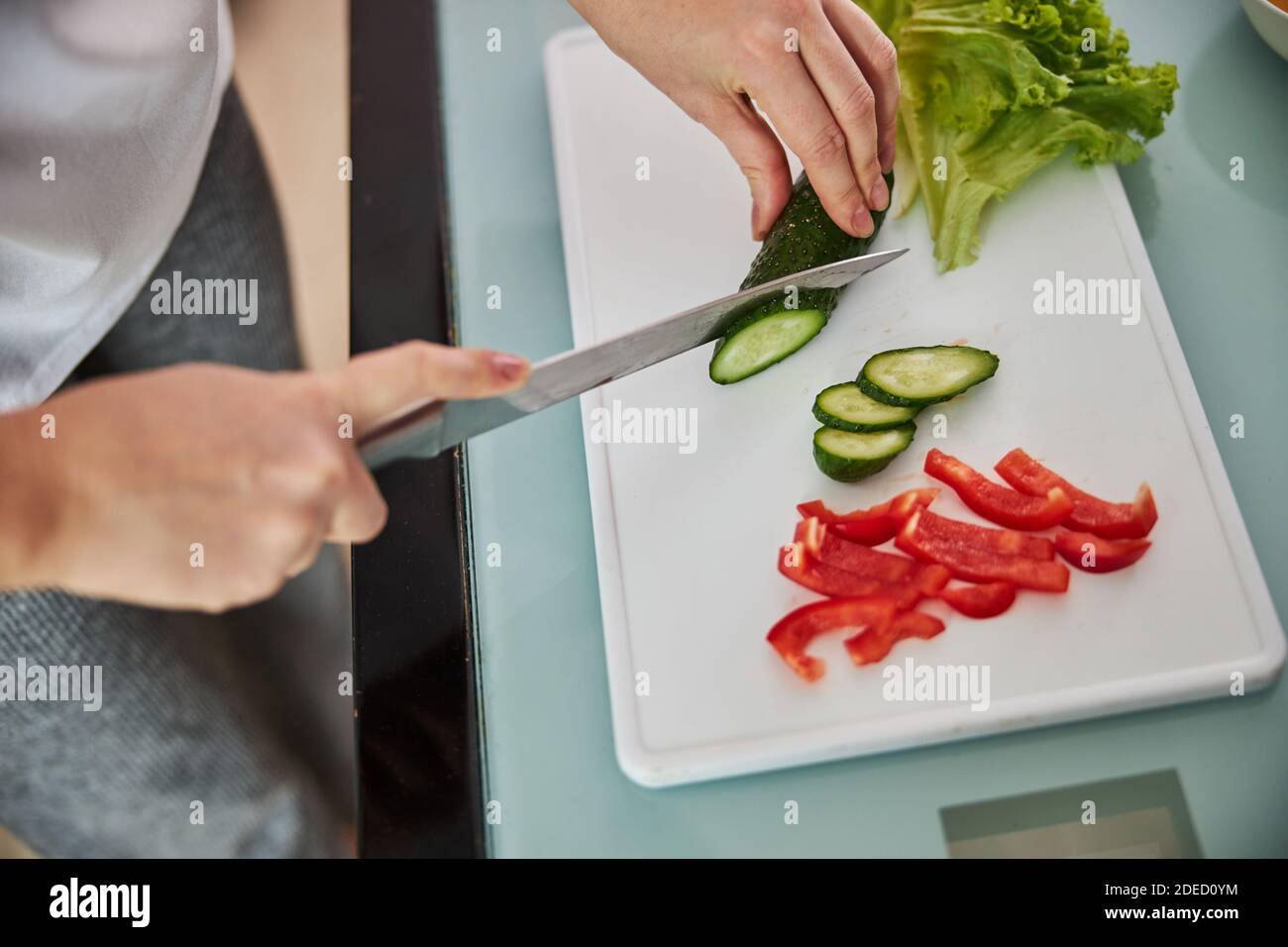 Woman slicing a cucumber hi-res stock photography and images - Alamy