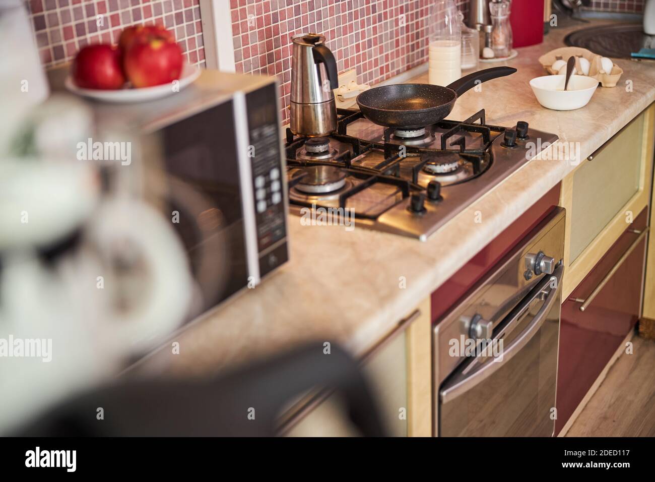 Frying pan and kettle standing on a cooker Stock Photo - Alamy