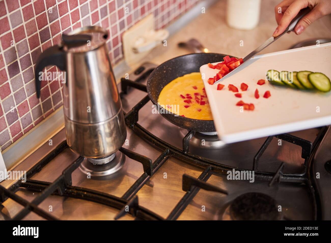 Person spilling out sliced pepper into a pan Stock Photo - Alamy