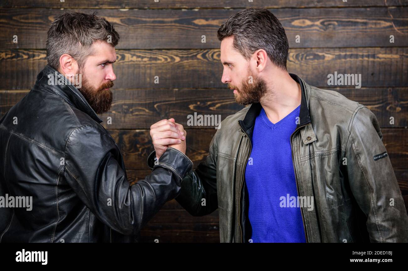 Have agreed. Brutal bearded men wear leather jackets shaking hands ...