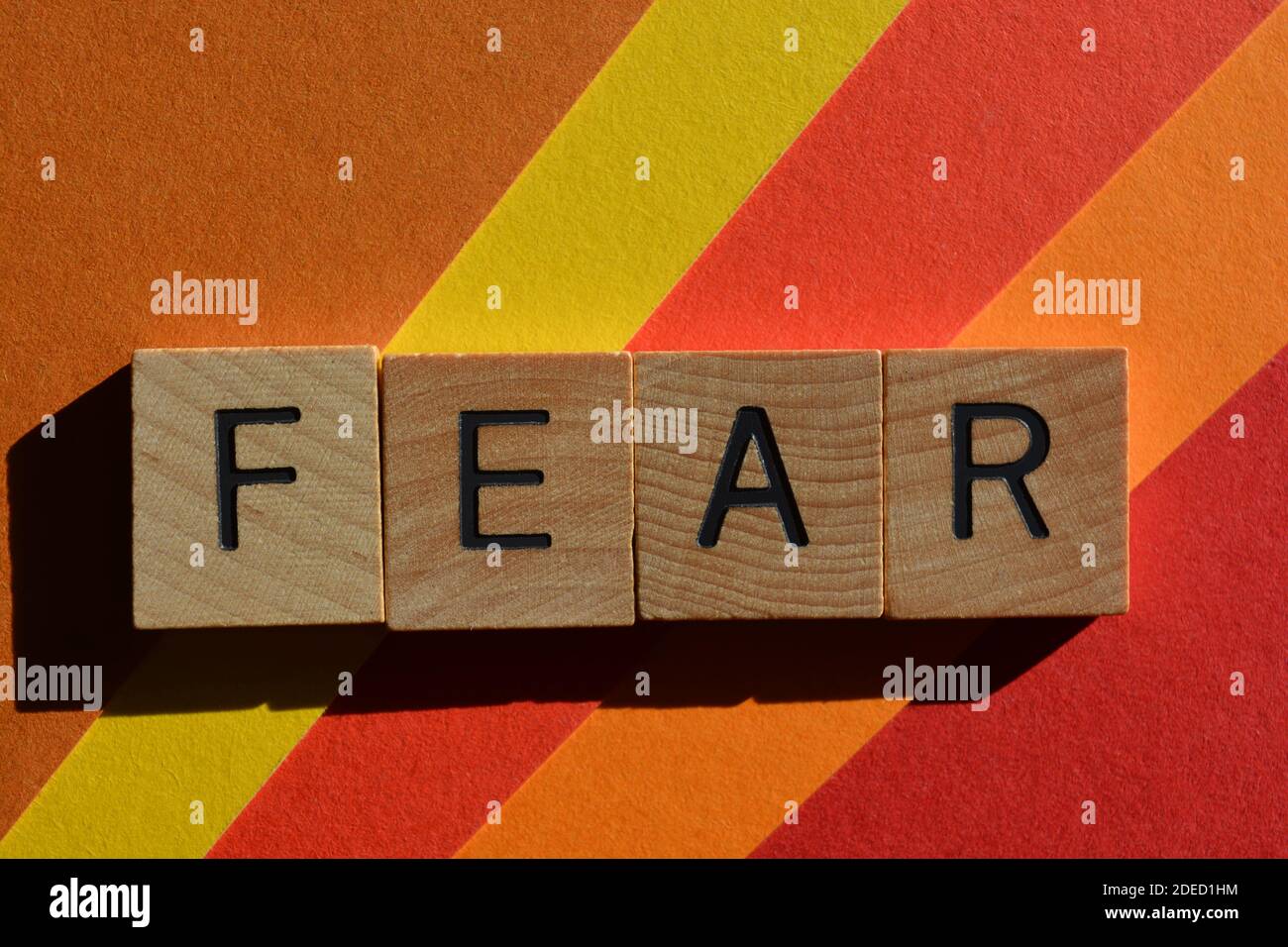 Fear, word in wooden alphabet letters isolated on colourful background ...