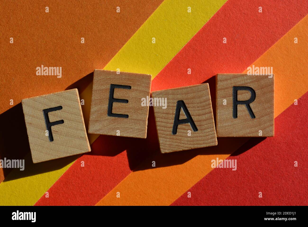 Fear, word in wooden alphabet letters isolated on colourful background ...