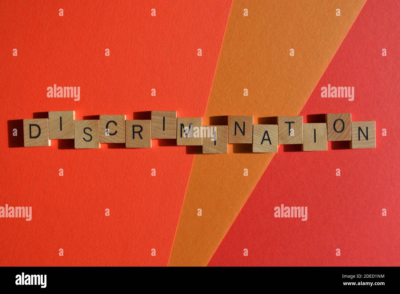 Discrimination, word in wooden alphabet letters isolated on red ...