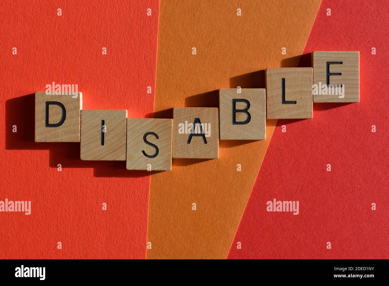 Disable, word in wooden alphabet letters isolated on colourful ...