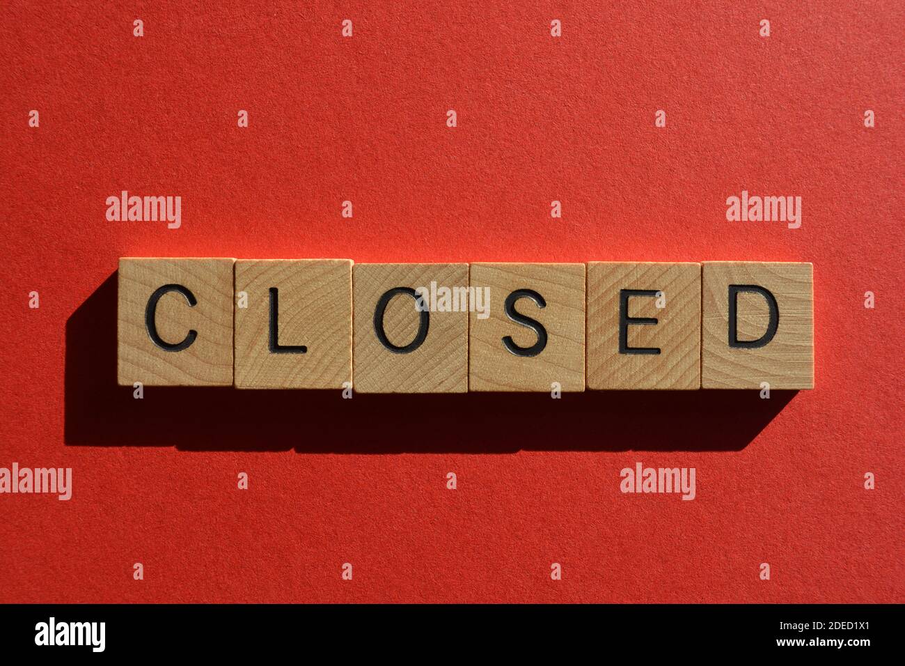 Closed, word in wooden alphabet letters isolated on red background ...