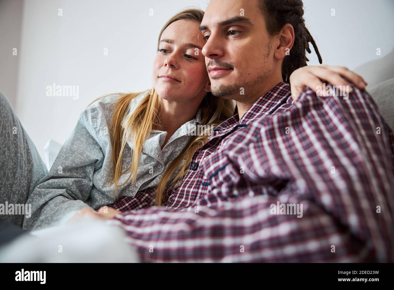 Beautiful young couple cuddling in bed at home Stock Photo - Alamy